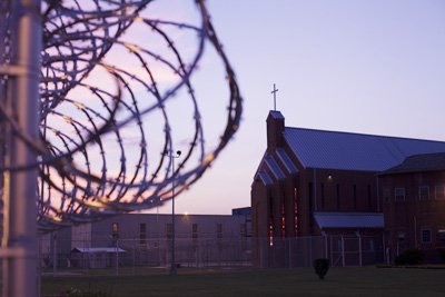 Volunteers, inmates experience God behind prison walls