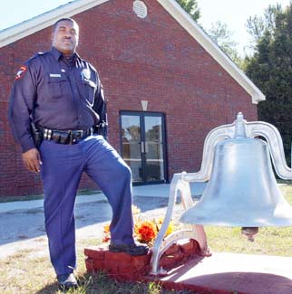 Pastor/policeman carries a Bible, wears a badge